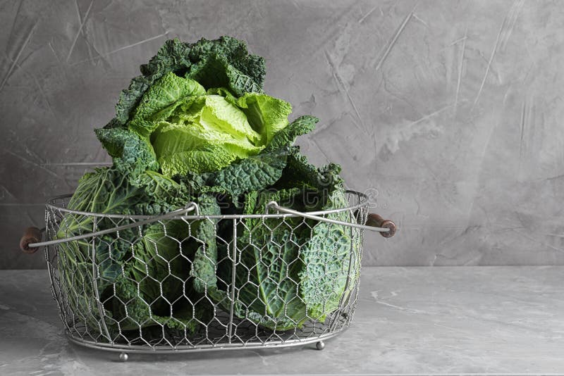 Fresh Green Savoy Cabbage in Basket on Table Against Grey Background ...
