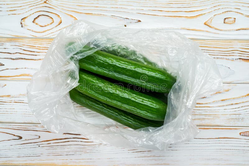 Cucumbers in Plastic Packaging on a Wooden Table Stock Image - Image of ...