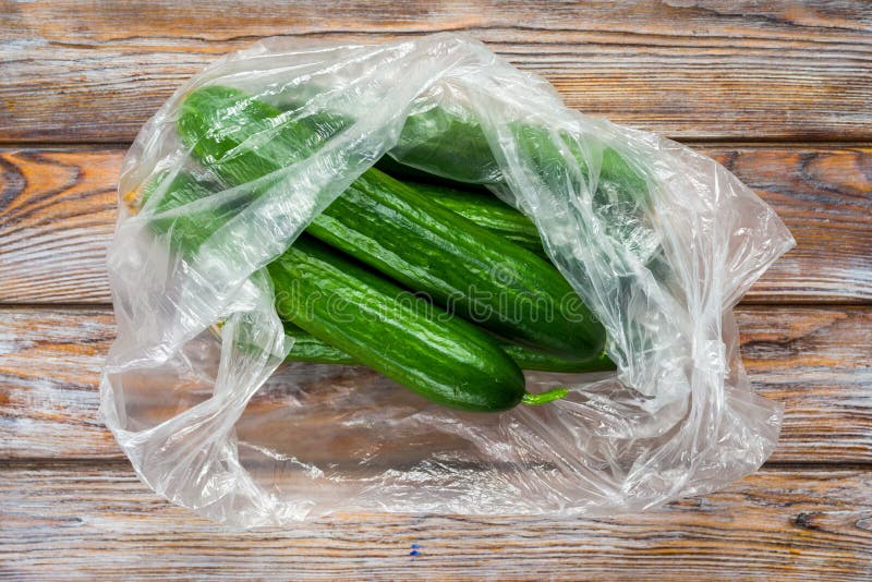 Cucumbers in Plastic Packaging on a Wooden Table Stock Photo - Image of ...
