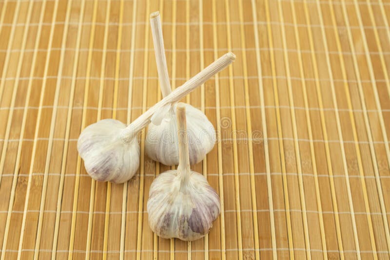 Fresh Head of Garlic Three Root Vegetables Stands on a Wooden Mat Stock ...