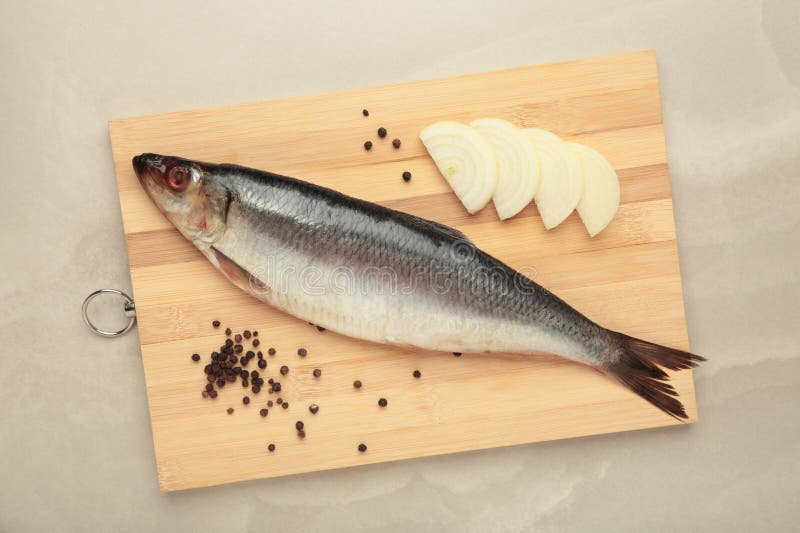 Fresh Herring Fish on Cutting Board on Grey Background Stock Photo ...
