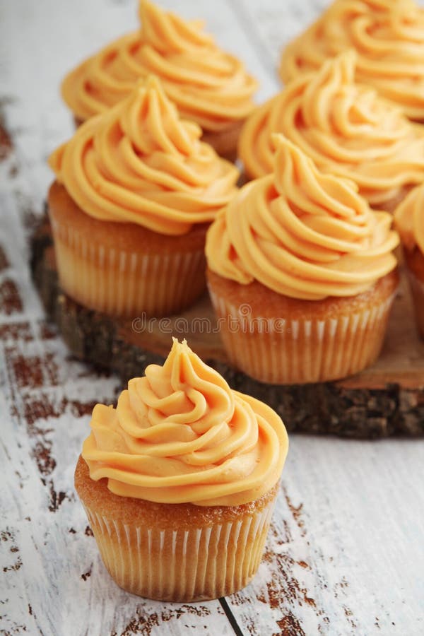 Cupcakes with Orange Icing on Top Stock Photo - Image of frosting ...