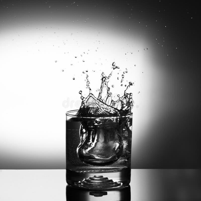 Fresh Ice Cube Falling To Glass of Water Splash Isolated Stock Photo ...