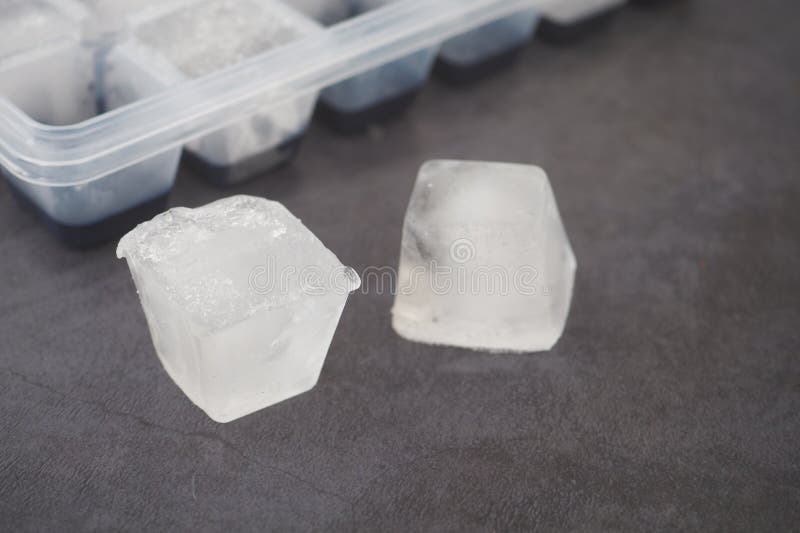 Fresh Ice Cubes Placed on a Dark, Smooth Surface with a Cool Appearance ...