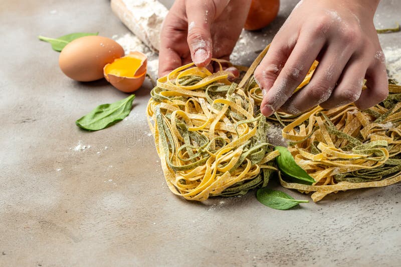 Fresh Italian Uncooked Homemade Pasta. Hands Making Pasta Tagliatelle ...
