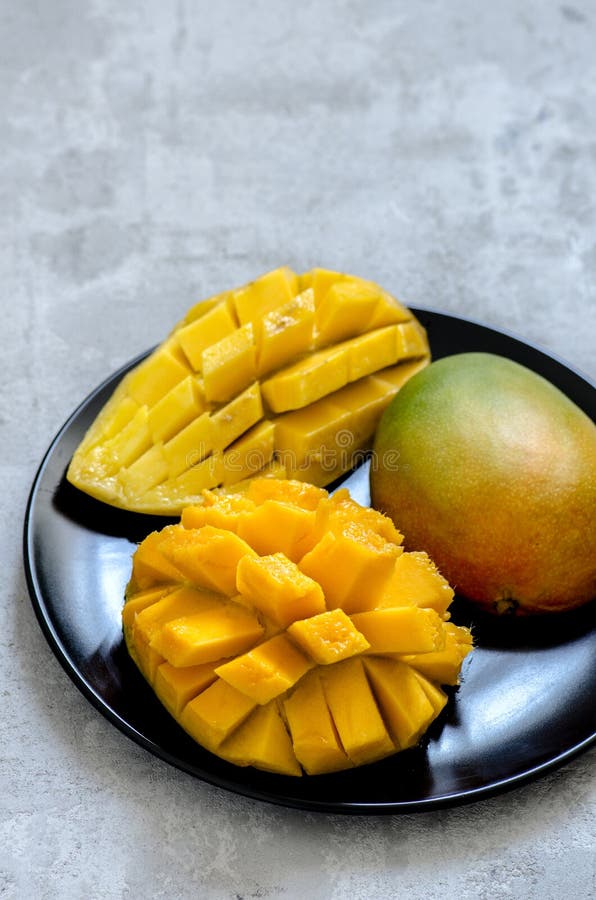 Fresh Juicy Mango Cut on a Black Plate Stock Image - Image of dessert ...