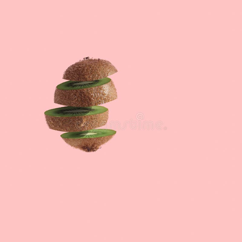 Fresh Kiwi Split into Pieces in Midair Against a Pink Pastel Backdrop ...