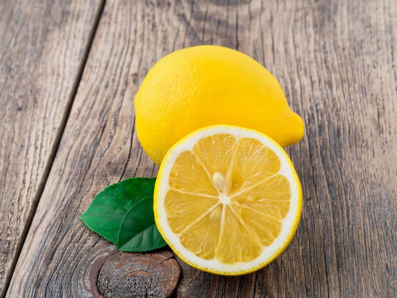 Fresh Lemon and Cut Off Half on Wooden Old Table, Side View Stock Photo ...