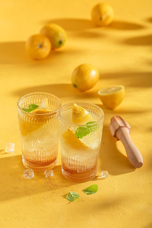 Fresh Lemonade with Ice on Yellow Wooden Table Stock Photo - Image of ...