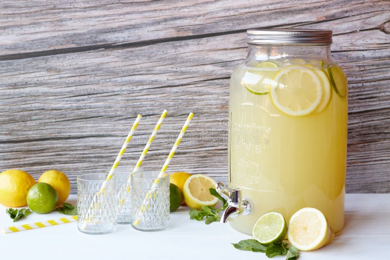 Fresh Lemonade with Lemons and Lime in the Beverage Dispenser Stock ...