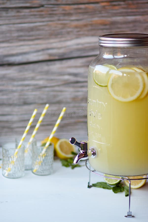 Fresh Lemonade with Lemons and Lime in the Beverage Dispenser Stock ...
