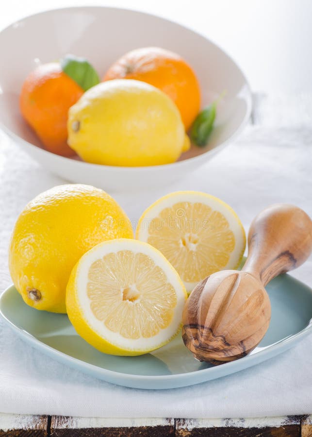 Fresh Lemons Cut in Half on Blue Plates Stock Photo - Image of ...