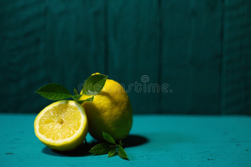 Fresh Lemons with Green Leaves on a Beautiful Dark Background, Front ...