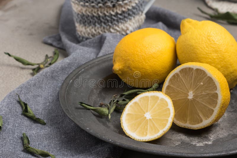 Fresh Lemons and Lemons Leaves on Rustic Plate. Fresh Citrus Fruit ...