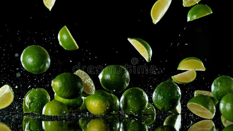 Fresh Lime Slices Falling Down on Black Background Stock Photo - Image ...