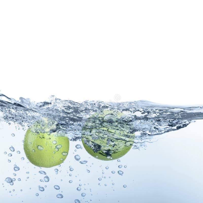 Fresh Limes Falling into Water Against White Background Stock Photo ...