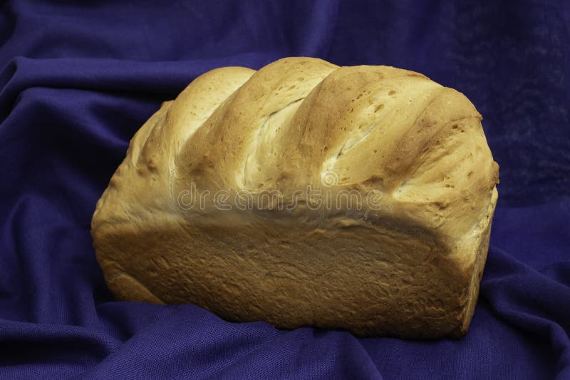 Fresh Loaf of Bread on Blue Fabric Stock Image - Image of cuts ...