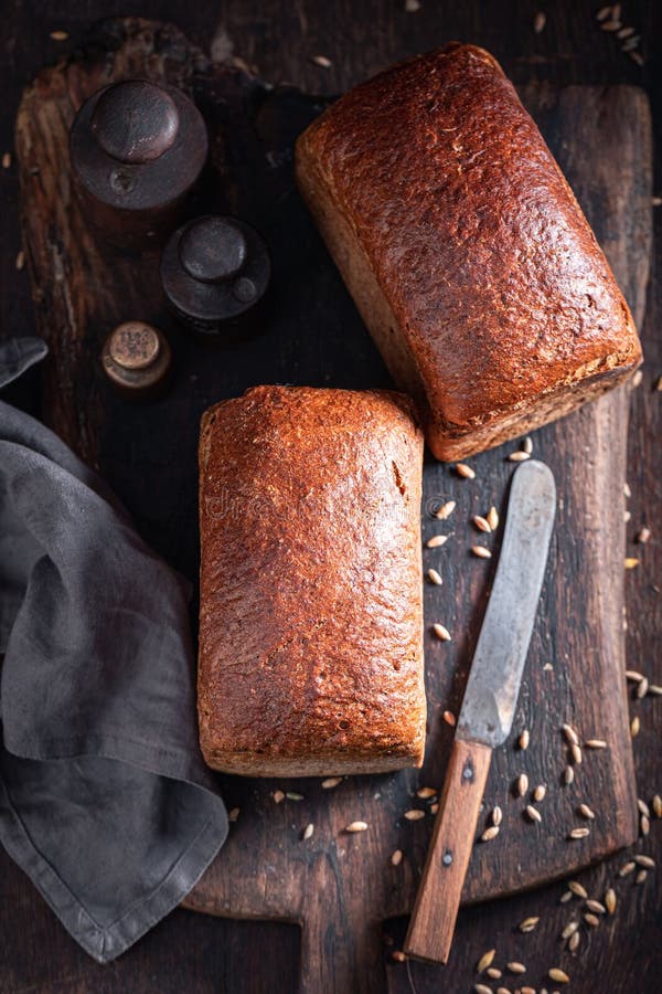 Fresh Loaf of Breads with Grain and Ears Stock Photo - Image of board ...
