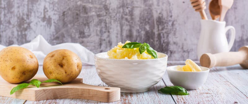 Fresh Mashed Potatoes and Basil Leaves in a Bowl and Whole Potatoes on ...