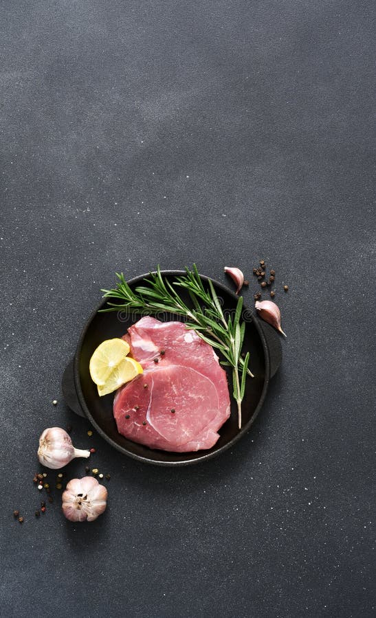 Fresh Meat in a Cast Iron Pan, Raw Pork with Spices on a Black ...