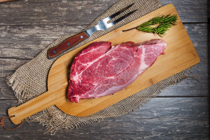 Fresh Meat on a Cutting Board with a Fork Stock Photo - Image of fresh ...