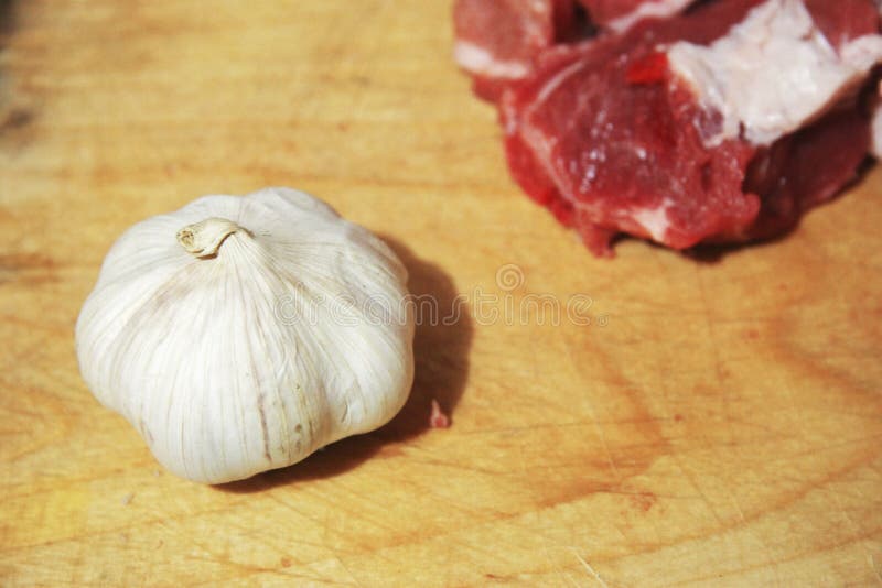 Fresh Meat and Fresh Garlic Laying on the Kitchen Desk Stock Photo ...