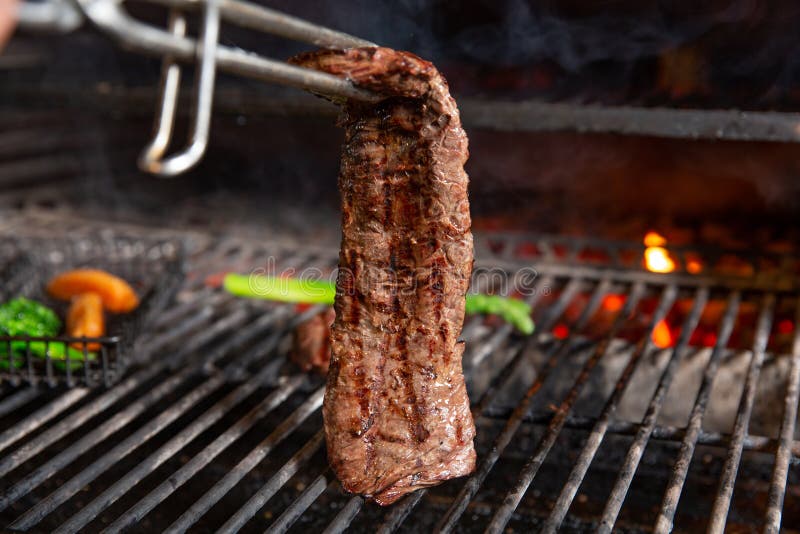 Fresh Meat on Hot Grilled Cook with Forceps Closeup View Stock Photo ...