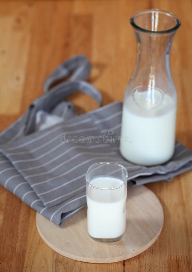 Fresh Milk on a Table with a Jug of Milk on the Wooden Table. Stock ...