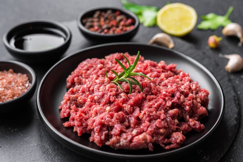 Fresh Minced Meat Ground Beef on a Black Plate Against Stone Background ...