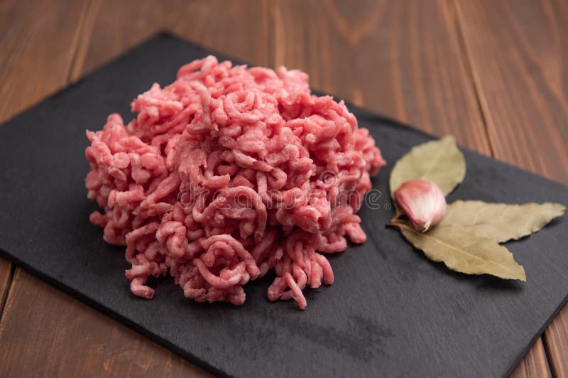 Fresh Minced Pork on Black Plate and Wooden Background. Stock Photo ...