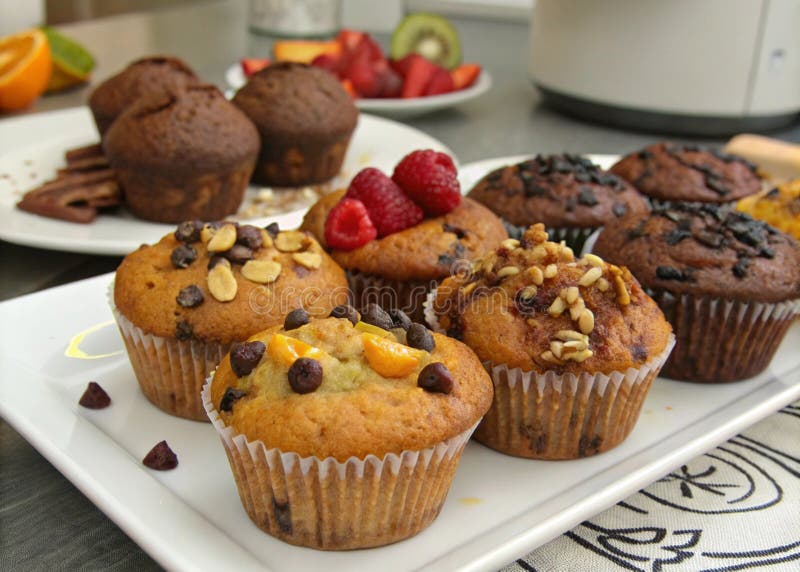 Fresh Muffins with Assorted Toppings and Fruit Slices on a Vibrant ...