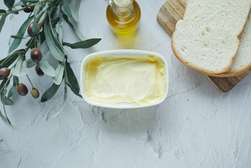 Fresh Olive Butter in a Container with Bread on White Background Stock ...