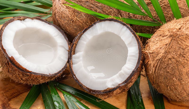 Fresh Opened Coconuts Along with Whole Coconuts and Coconut Leaves on a ...