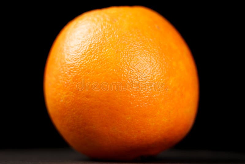 Fresh Orange Fruit with Textured Rind Surface on a Black Backdrop Stock ...
