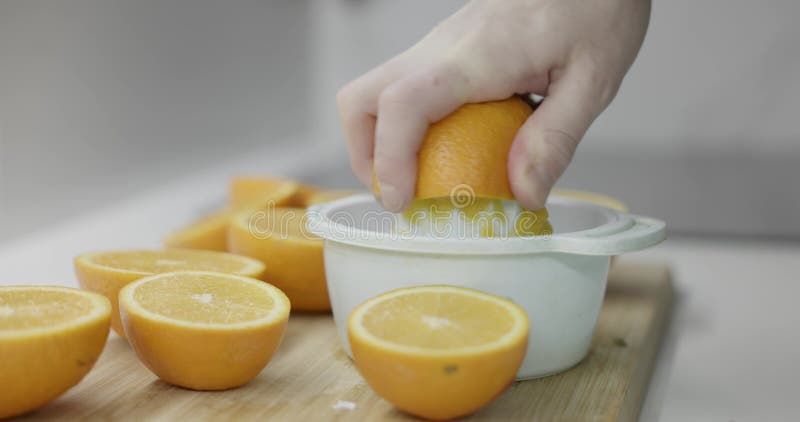 Fresh Orange Juice Being Squeezed by Hand Stock Footage - Video of ...