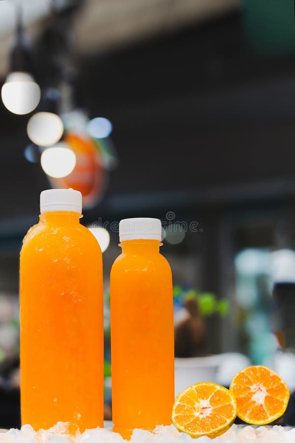 Fresh Orange Juice and Cut Half Orange Slice on Ice Cube. Stock Image ...