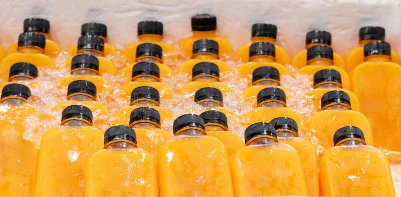 Fresh Orange Juice in Transparent Plastic Bottles Soaked in Ice ...