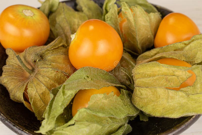 Fresh Orange Physalis on Grey Wood Stock Photo - Image of heap ...