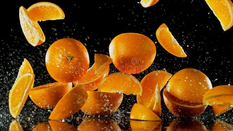 Fresh Orange Slices Falling Down on Black Background Stock Image ...