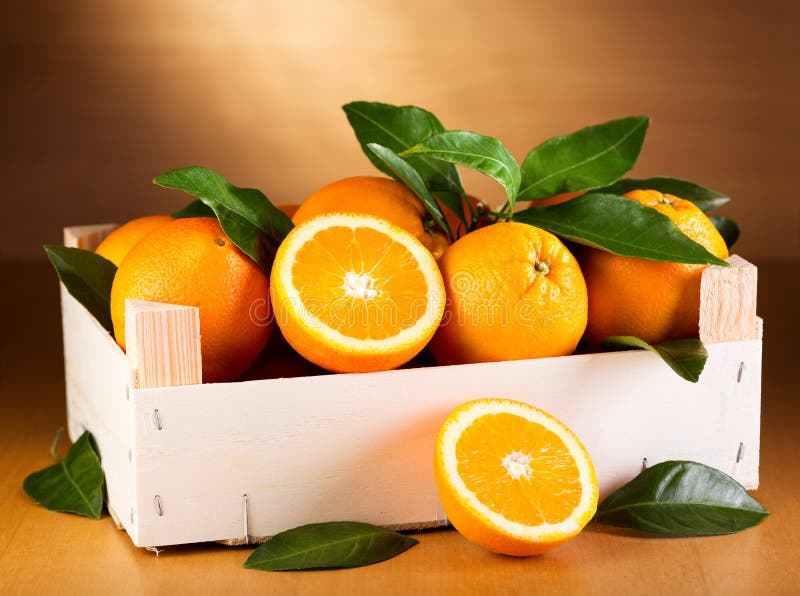 Fresh oranges with leaves stock image. Image of fruit - 36487069