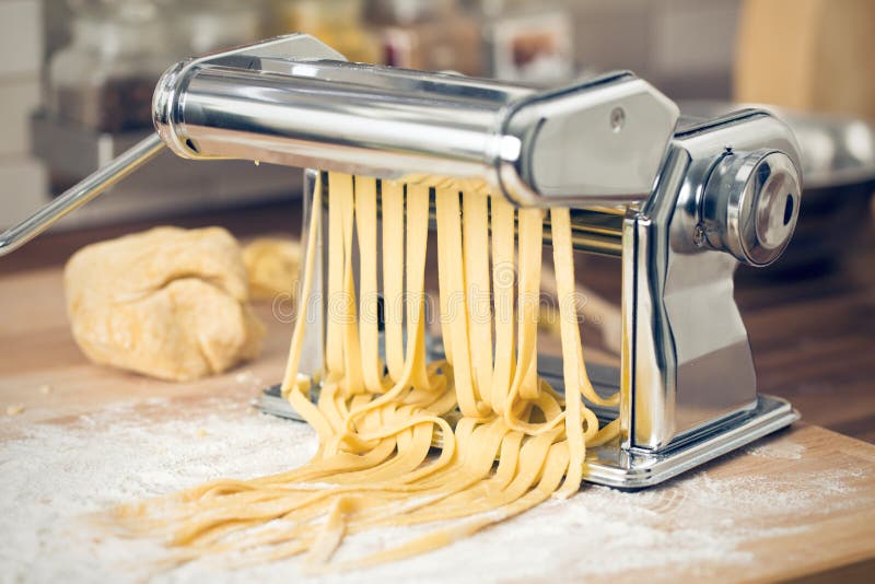 Fresh Egg Pasta Being Rolled in a Pasta Machine Stock Image - Image of ...