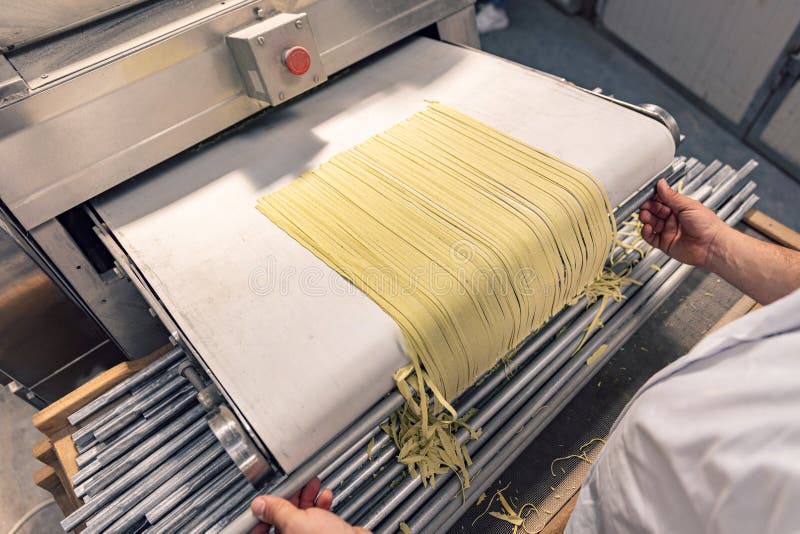 Fresh pasta production stock photo. Image of control - 318780254