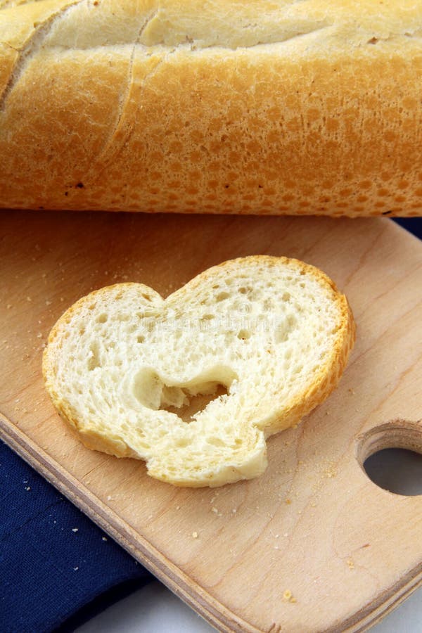 Fresh Piece of Bread in a Heart Shaped Stock Photo - Image of luck ...