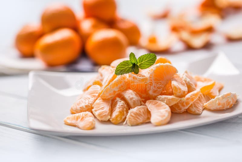 Fresh Pieces of Tangerines Mandarin on the Plate or in a Bowl Stock ...