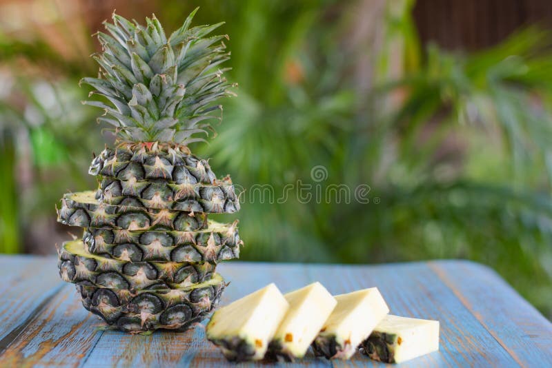 Fresh Pineapple Slices on Blue Wood Texture Stock Photo - Image of ...