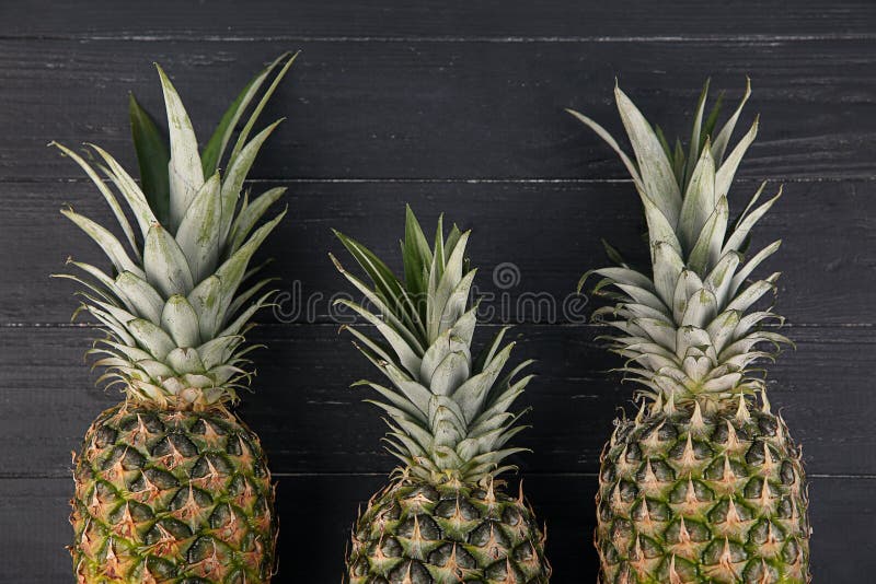 Fresh Pineapples on Dark Wooden Background Stock Photo - Image of ...