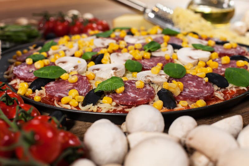 Fresh Pizza Ready To Be Cooked with All the Ingredients Around Stock ...