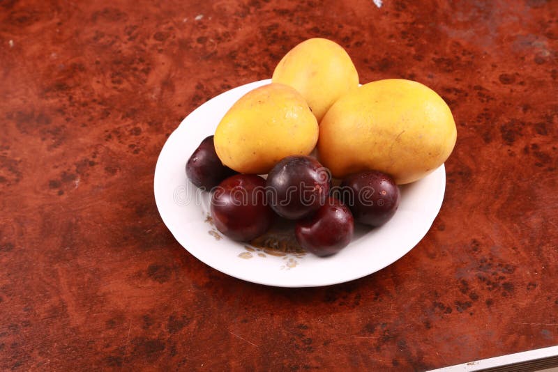 Fresh plum and mango stock photo. Image of background - 110640316