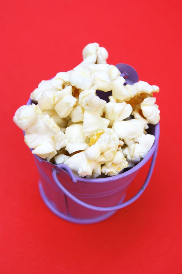 The Fresh Popcorn in a Small Decorative Iron Bucket on a Red Background ...