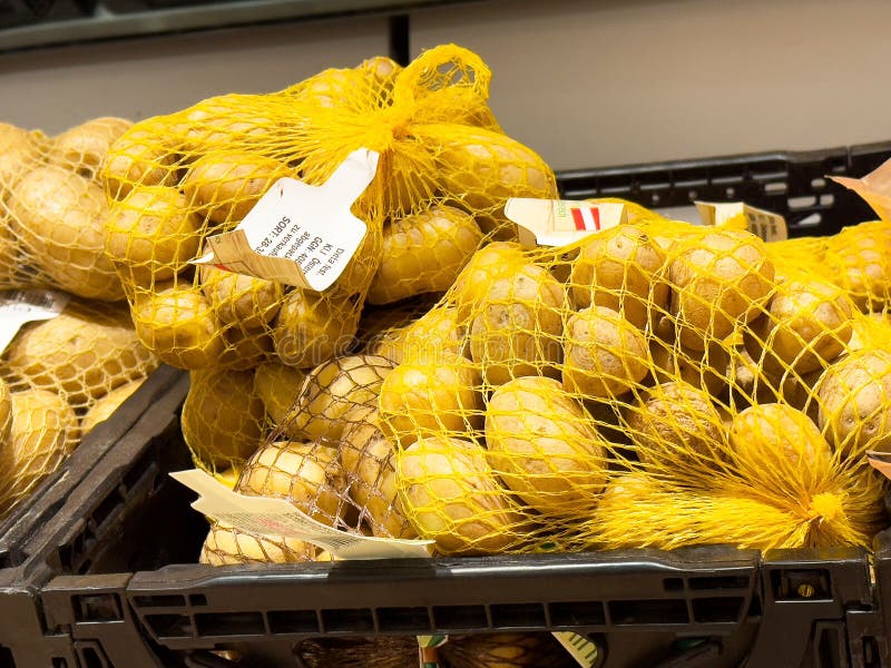 Fresh Potatoes in Net Bags at Grocery Store Display Editorial ...